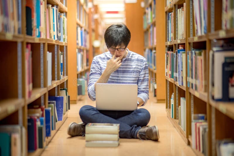 Young Asian University Student Using Laptop in Library Stock Photo ...