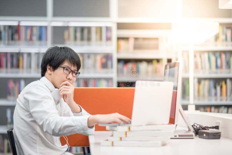 Young Asian Man University Student Working in Library Stock Photo ...