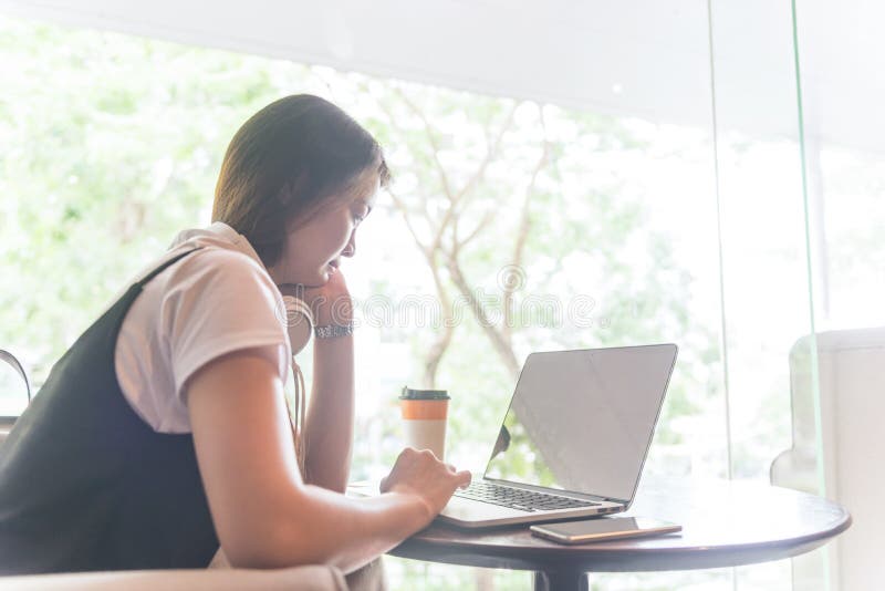 Young Asian Woman Checking Email on Laptop and Thinking Stock Photo ...