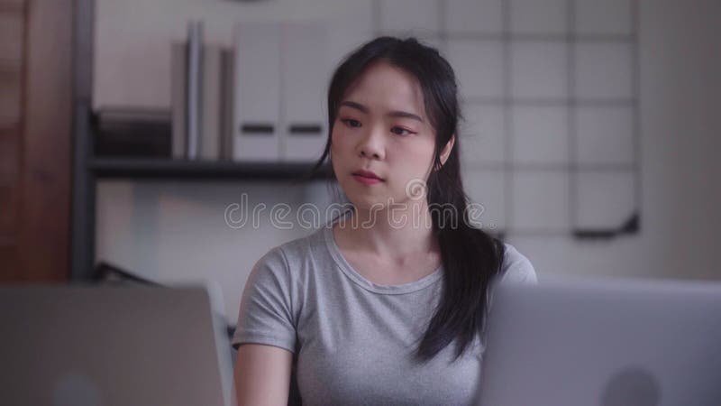 Young Asian Woman Hard Working with Documents at Her Using Laptop ...
