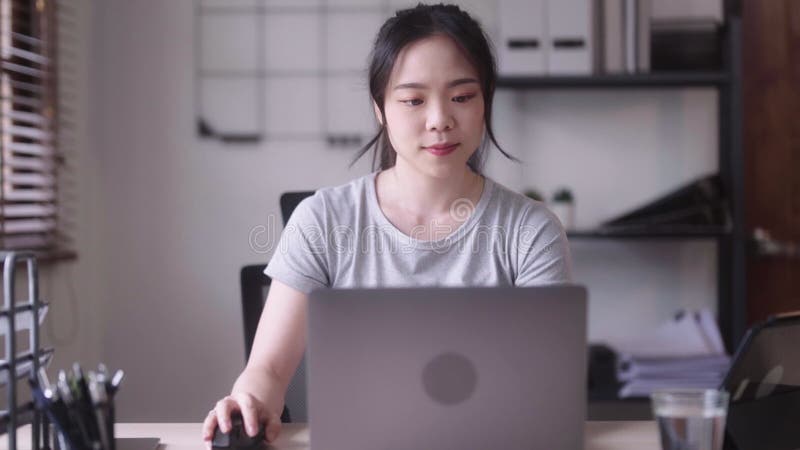 Young Asian Woman Hard Working with Documents at Her Using Laptop Computer with Analytical ...