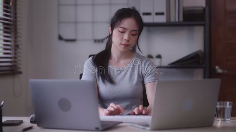 Young Asian Woman Hard Working with Documents at Her Using Laptop ...