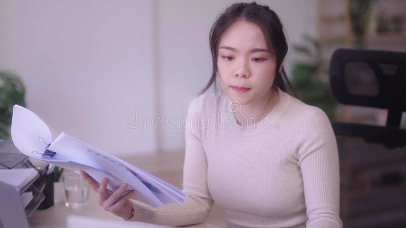 Young Asian Woman Hard Working with Documents at Her Using Laptop ...