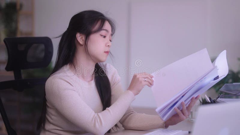 Young Asian Woman Hard Working with Documents at Her Using Laptop ...
