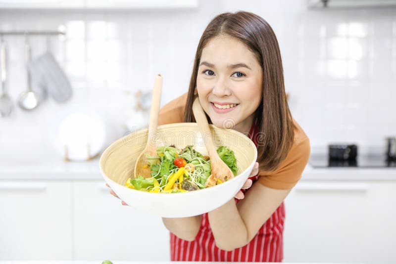 A Young Asian Woman Making Salad in a Modern Kitchen Stock Image ...