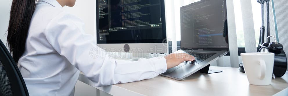 Young Asian Woman Programmer Typing Code Working With Computer At Table Coding Cyberspace And