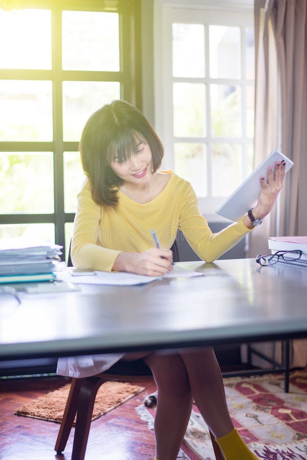 Young Asian Woman Students Using Tablets and Writing Note in College ...