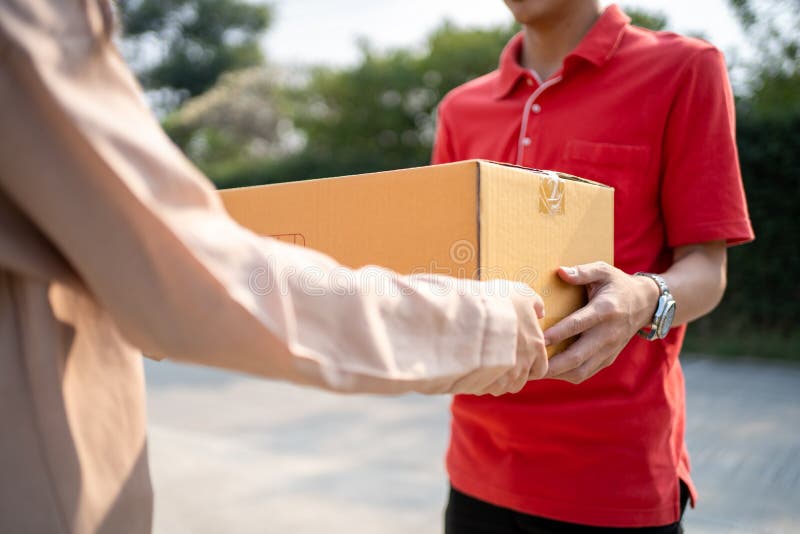 Young Asian Woman Taking a Box from the Postman at the Door Stock Photo ...