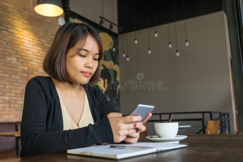 Young Asian Woman Text Message on Smarphone with Both Hands Stock Photo ...