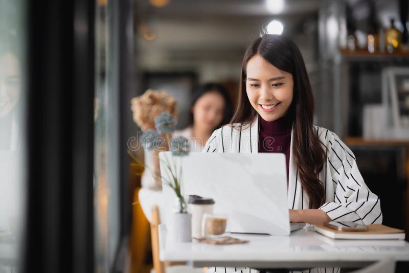 Young Asian Woman Using Laptop in Coffee Shop. Stock Photo - Image of ...