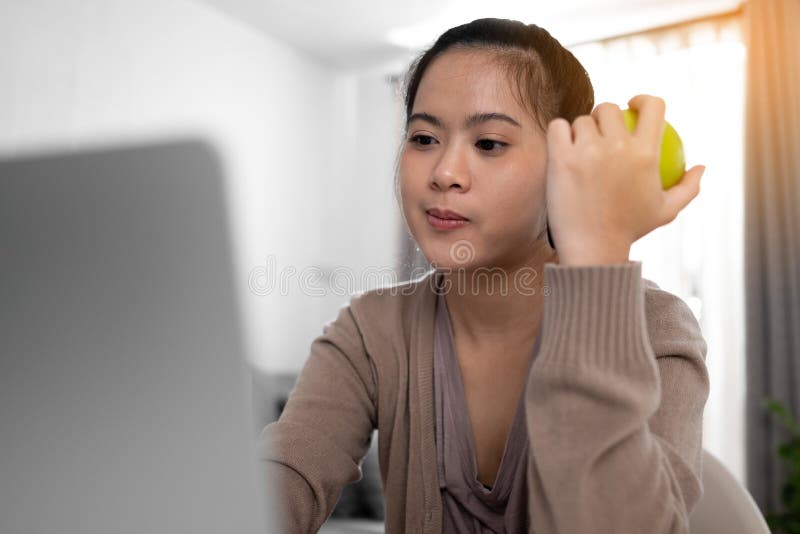 Young Asian Woman Using Laptop for Work with Green Apple Stock Photo ...