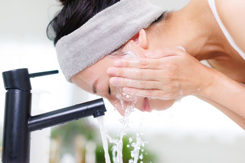 Young washing her face stock image. Image of clothing - 299913225