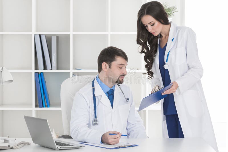 Young assistant and doctor stock image. Image of healthcare - 141496531