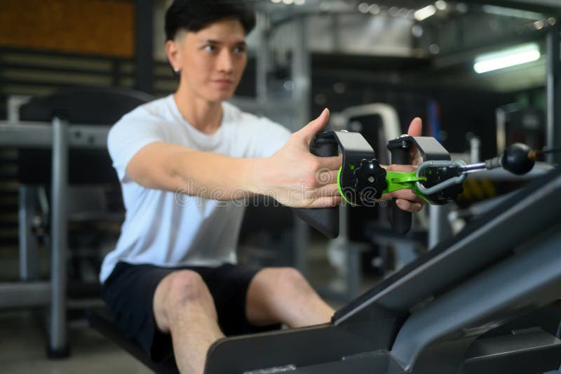 Young Athlete Doing Exercise and Pulling Weights in Seated Cable Row ...
