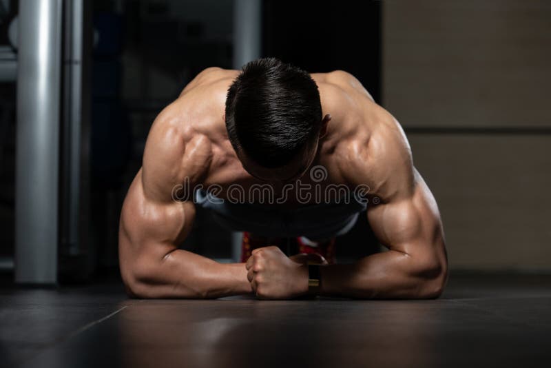 Young Man Doing Press Ups in Gym Stock Photo - Image of fitness, dark ...