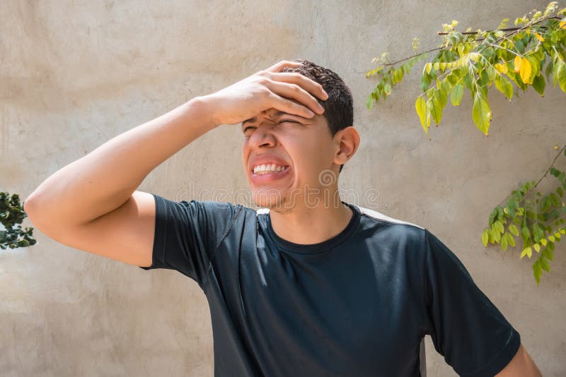 A Young Athlete Grabs His Forehead in Anger or Pain Stock Image - Image ...