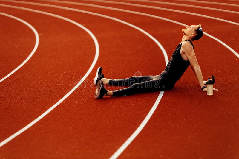 Young Athlete Resting after Running in the Stadium Stock Image - Image ...