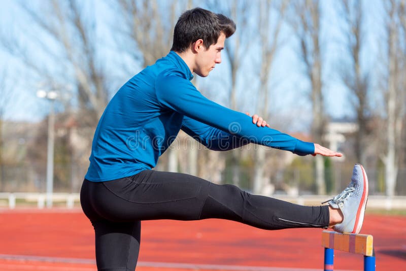Young Athlete Stretching on a Running Track. Stock Image - Image of ...