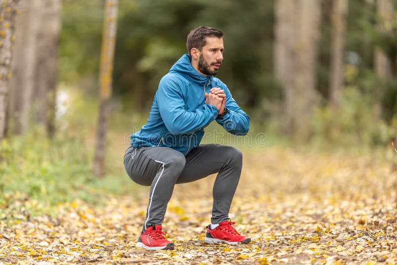A Young Athlete is Warming Up before Running Training in the Park Stock ...
