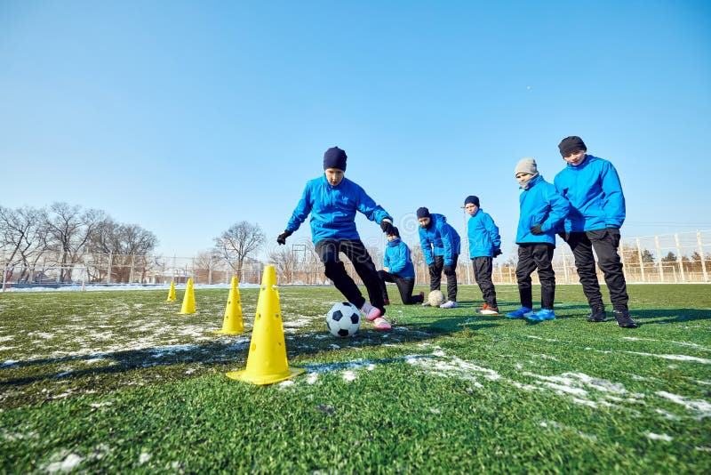Young Athlete Weaving Soccer Ball through Cones Under Coach S Guidance ...