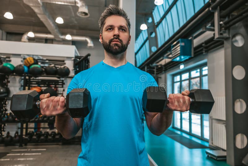 Young Athlete Working on His Muscles with Dumbbells Stock Image - Image ...