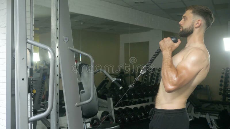 A Young Athletic Man with a Bare Torso is Engaged in Physical Work in ...