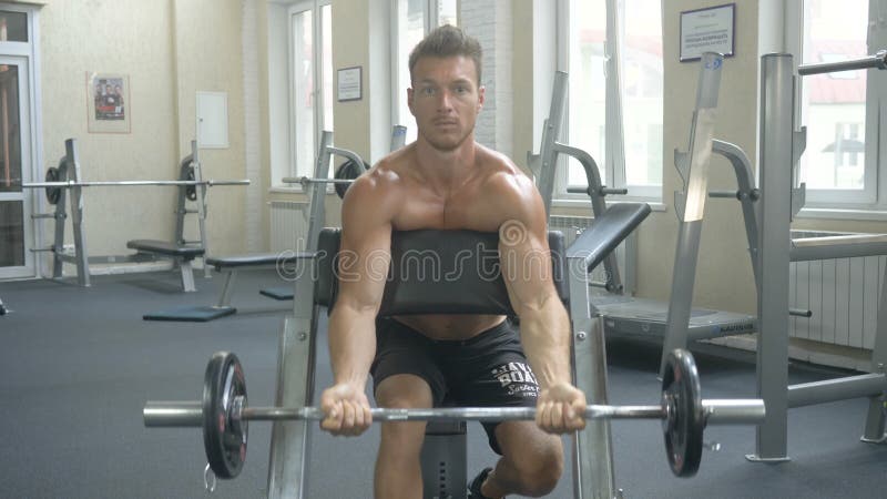 A Young Athletic Man with a Bare Torso is Engaged in Physical Work in ...