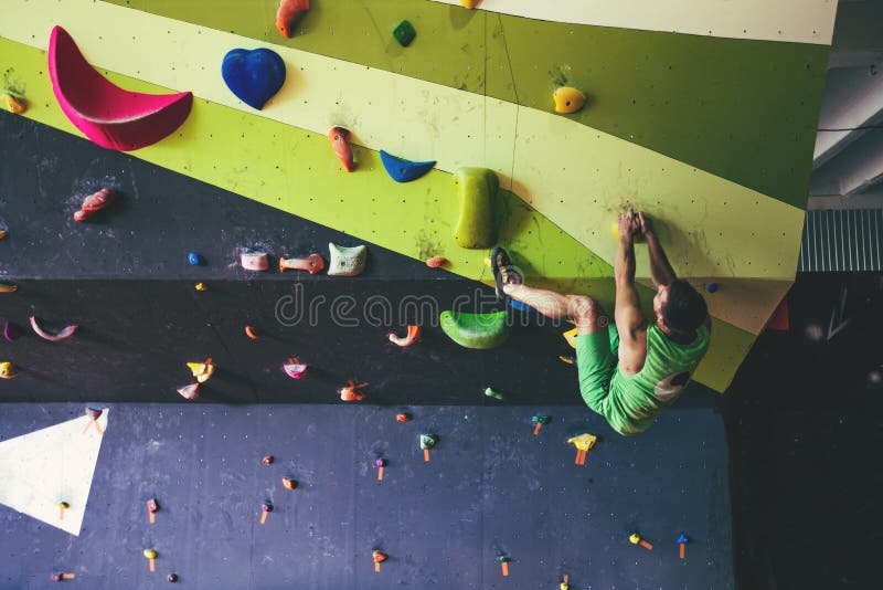 Man climbing boulder. stock photo. Image of exercise - 159219988