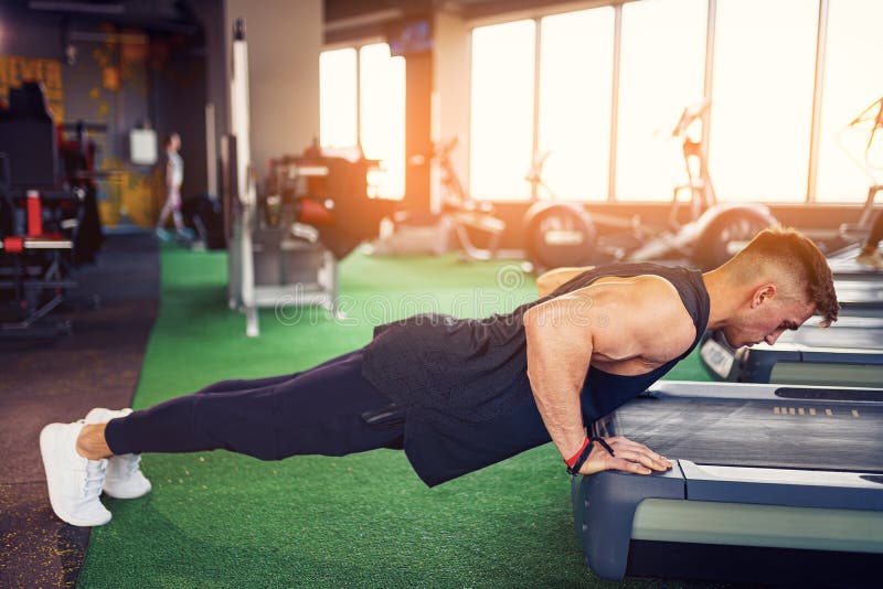 Young Athletic Man Doing Push-ups in Gym. Muscular and Strong Guy ...