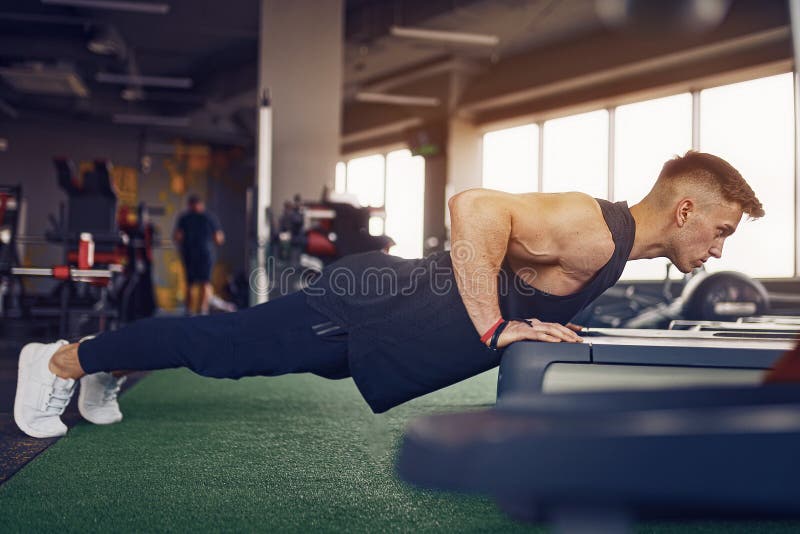 Young Athletic Man Doing Push-ups in Gym. Muscular and Strong Guy ...