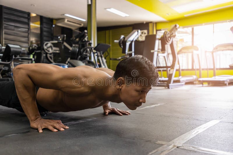 Young Athletic Man Doing Push-ups. Muscular and Strong Guy Exercising ...