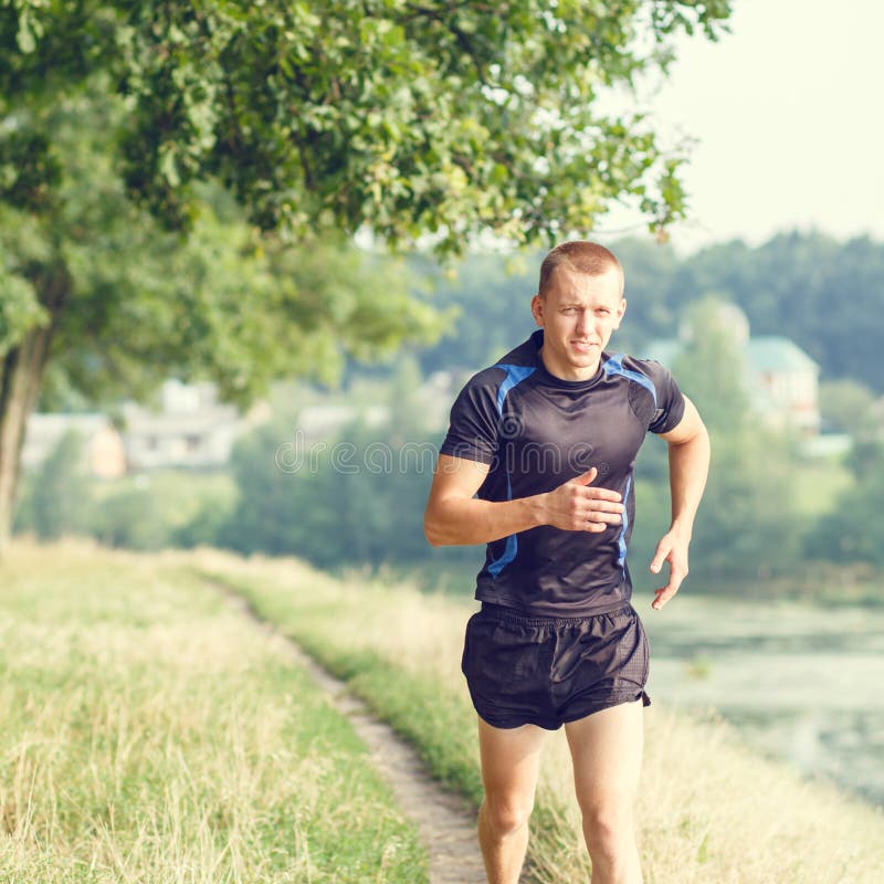 Young Athletic Man Jogging in Morning Park Stock Image - Image of ...