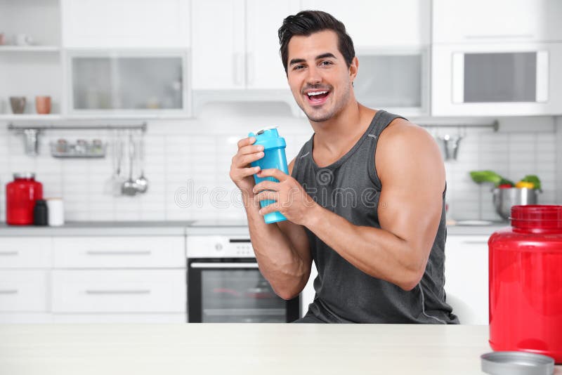 Young Athletic Man with Protein Shake in Kitchen, Space for Text Stock ...