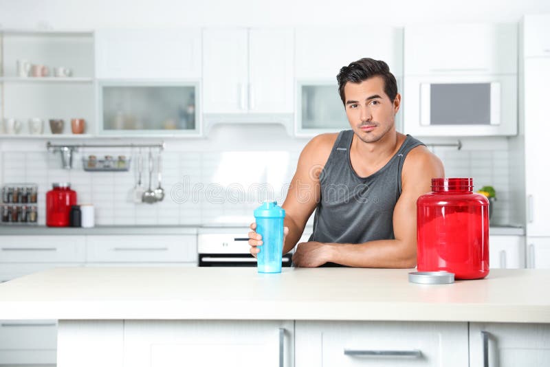 Young Athletic Man with Protein Shake Powder in Kitchen Stock Image ...