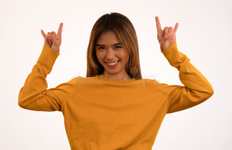 Young Attractive Asian Girl Smiling with Rock N Roll Pose in Studio ...