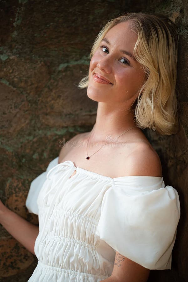 Young Attractive Caucasian Blonde Female Smiling And Posing In A White
