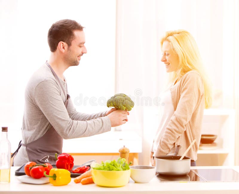 Young Attractive Couple Cooking in a Kitchen Stock Photo - Image of ...