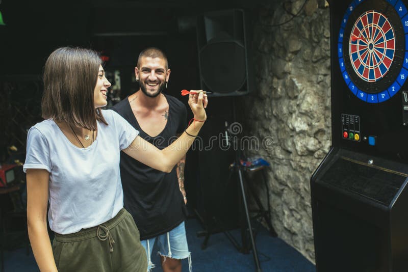 Young Attractive Couple Playing Darts Stock Image - Image of adults ...