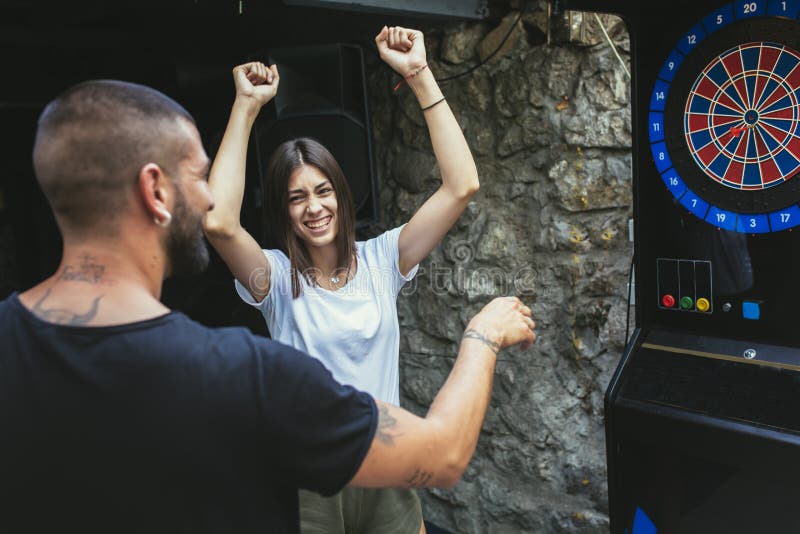 Young Attractive Couple Playing Darts Stock Image - Image of dart ...