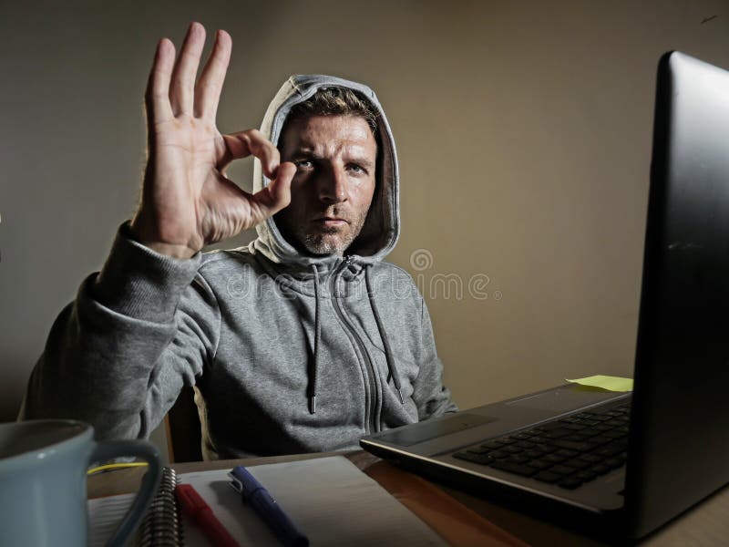 Young Attractive and Dangerous Looking Hacker Computer Geek Working on ...