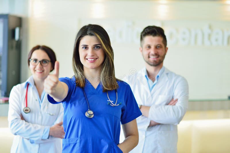 Young Attractive Female Doctor in Front of Medical Group. Stock Photo ...