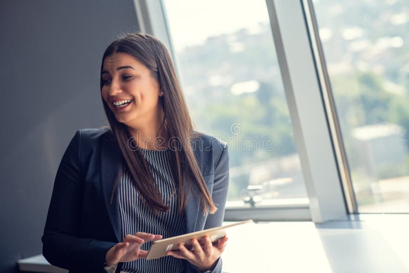 Young Attractive Female Manager Working on Digital Tablet while ...