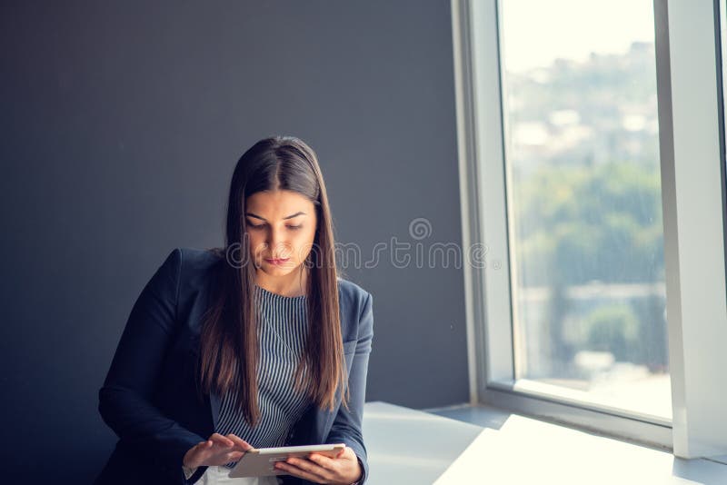 Young Attractive Female Manager Working on Digital Tablet while ...