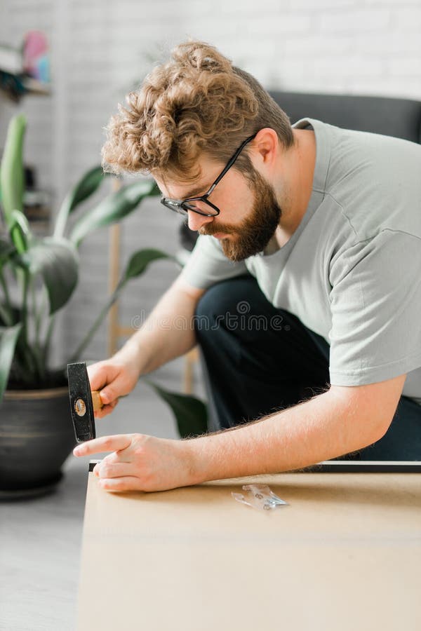 Young Attractive Man Assembles Furniture - Handwerker and Interior ...