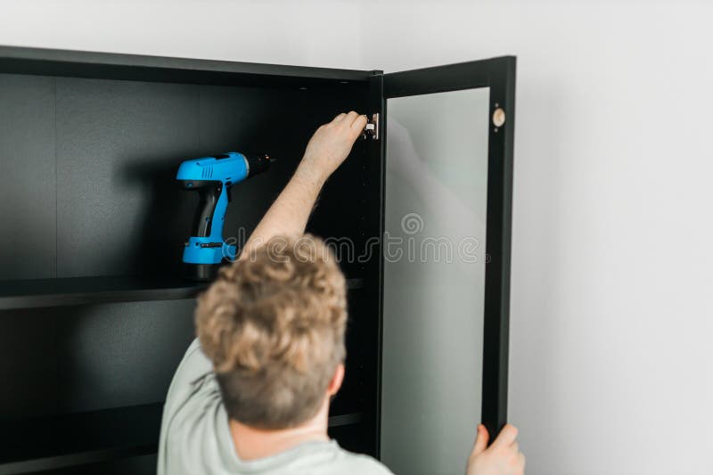 Young Attractive Man Assembles Furniture - Handwerker and Interior ...