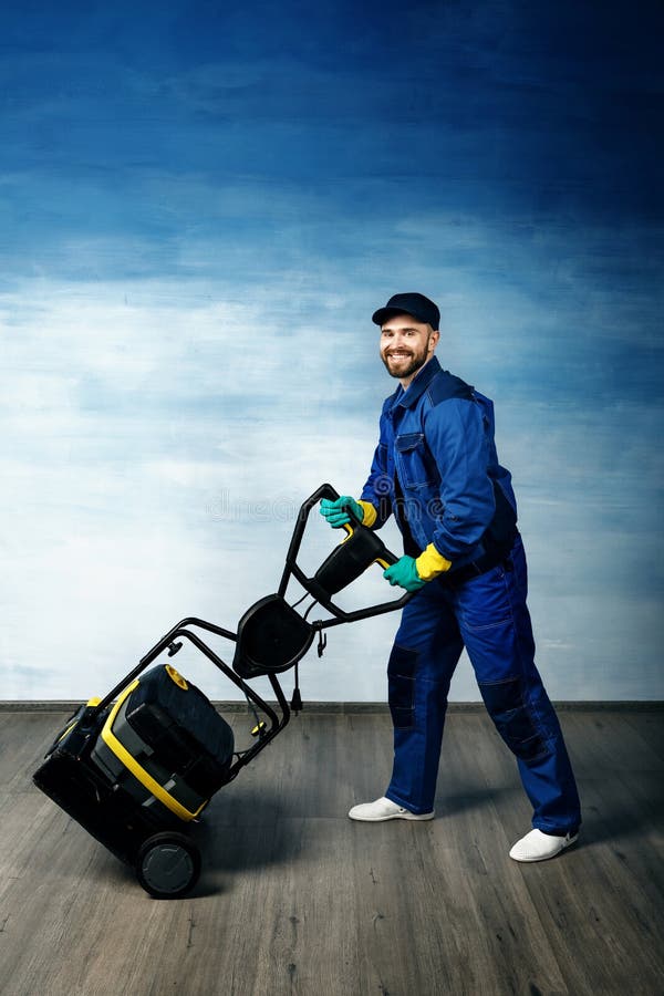 A Young Attractive Man with a Beard in a Working Uniform is Standing ...