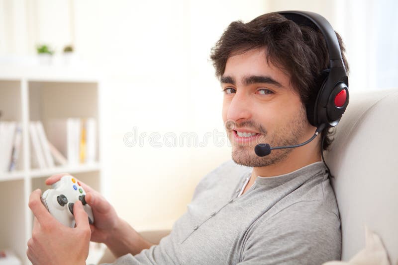 Young Attractive Man Playing Video Games in a Sofa Stock Photo - Image ...