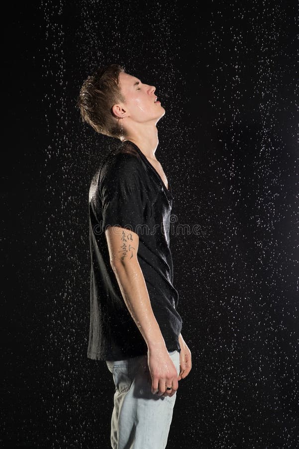 Young Attractive Man Standing Under Rain in Jeans and Tshirt Stock ... Young Attractive Man Standing Under Rain in Jeans and Tshirt Stock ...
