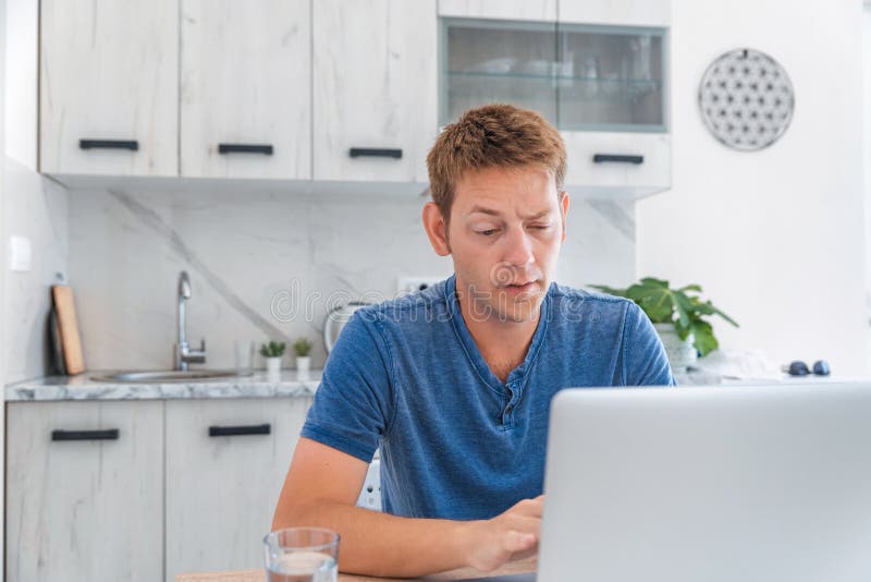 Young Attractive Man Working on Laptop Online at Home, Using Internet ...