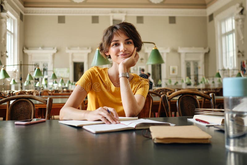 Young Attractive Smiling Female Student Happily Looking in Camera while ...